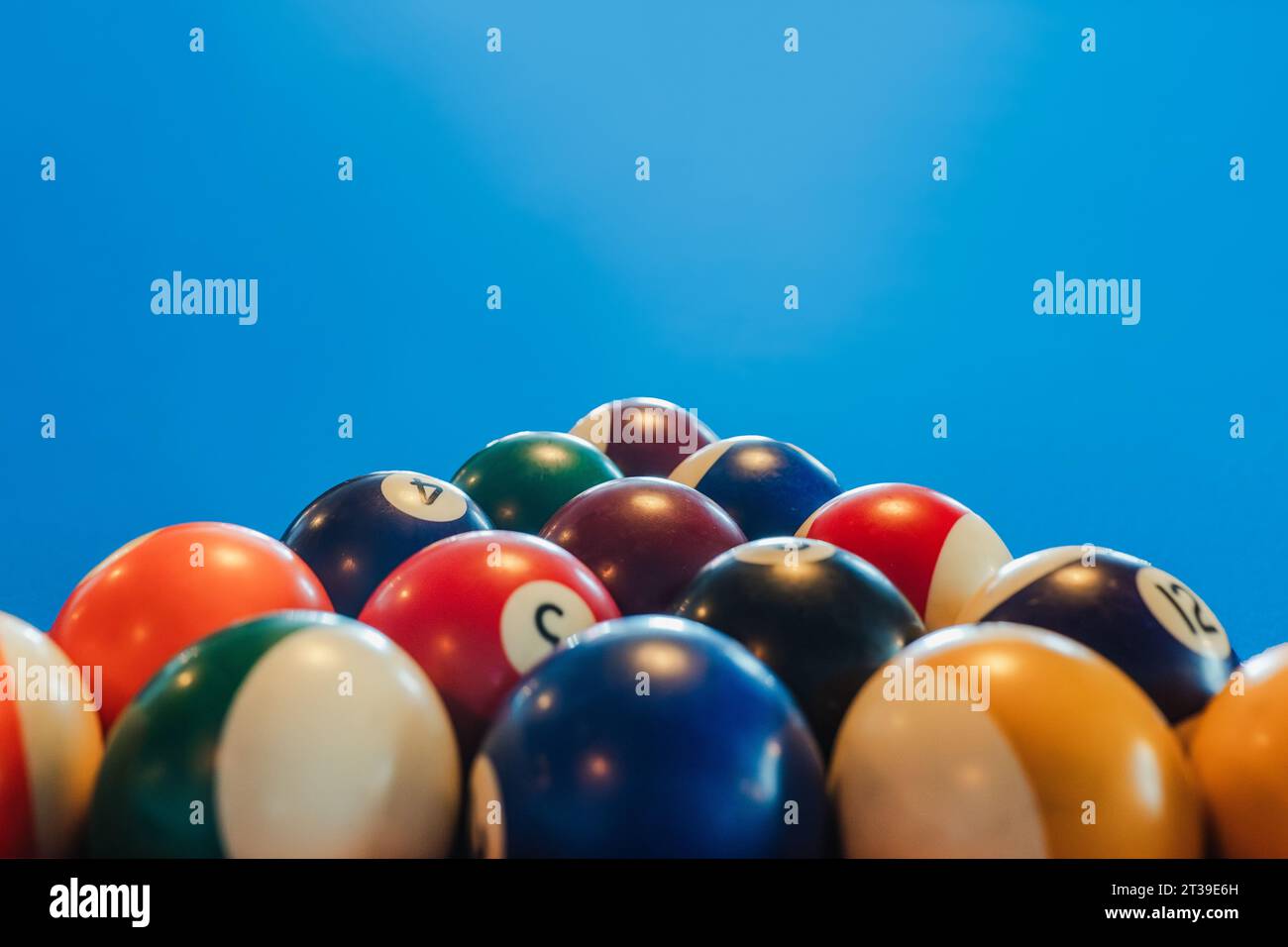 Closeup of crop colorful pyramid of billiard balls on blue pool table ...