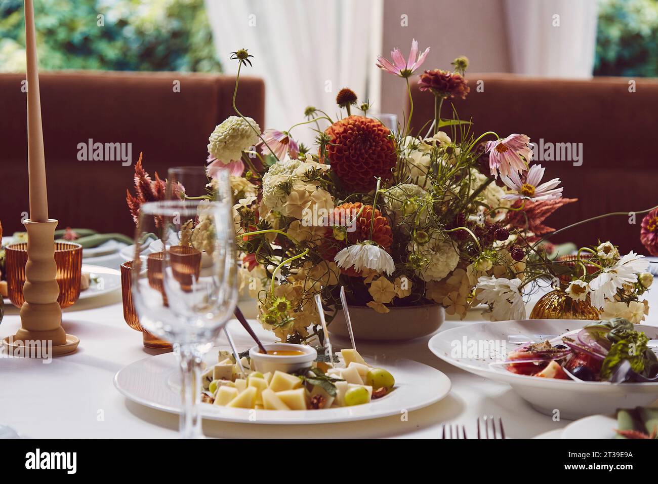 Graceful autumn aesthetics table setting and food, arranged flowers ...