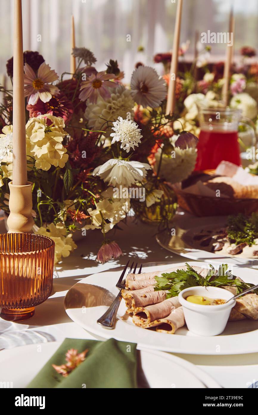 Restaurant autumn aesthetic table setting, flowers arrangement under ...