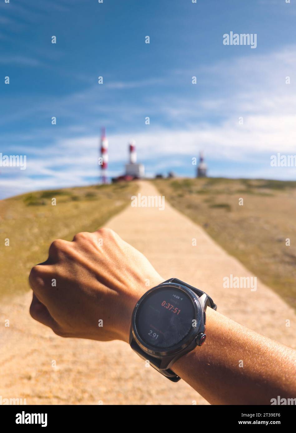 Closeup of modern round smart watch on crop anonymous male hand showing ...