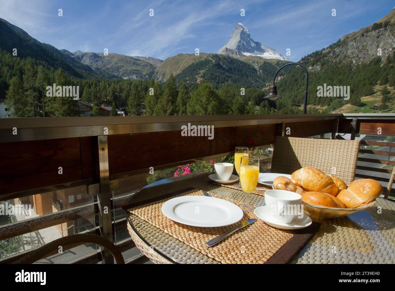 An outdoor dining setup overlooking the majestic Matterhorn mountain ...