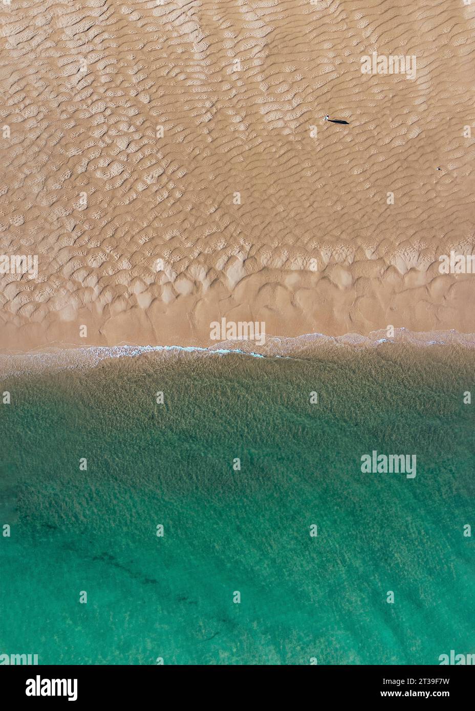Aerial top view of unrecognizable traveler walking along turquoise ...