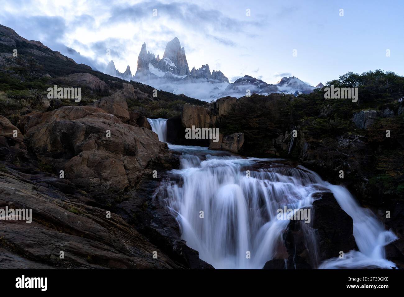 Photo of a majestic waterfall surrounded by the stunning landscape of ...