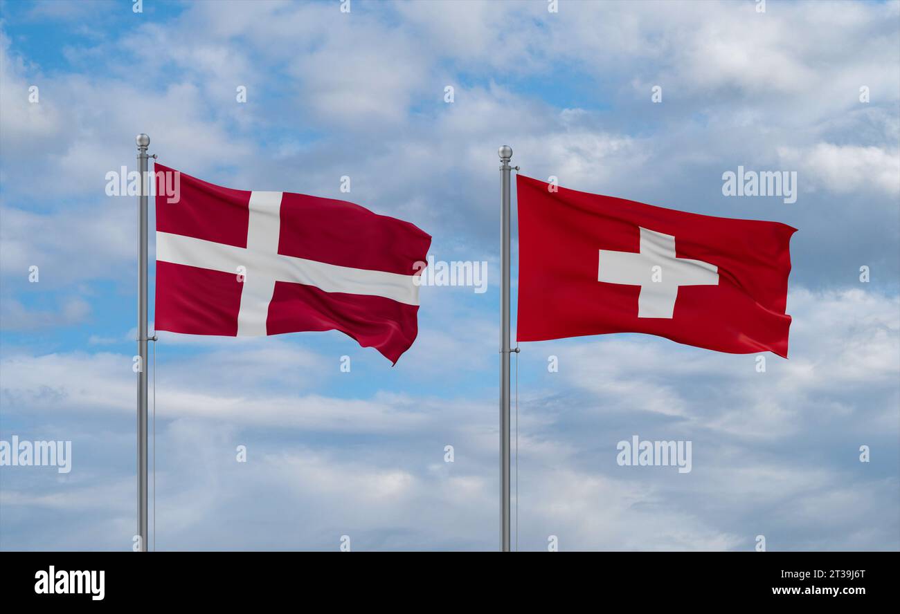 Switzerland and Denmark flags waving together in the wind on blue cloudy sky, two country ...