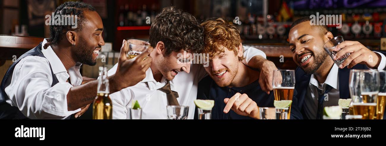 happy and drunk multiethnic friends hugging during bachelor party in ...