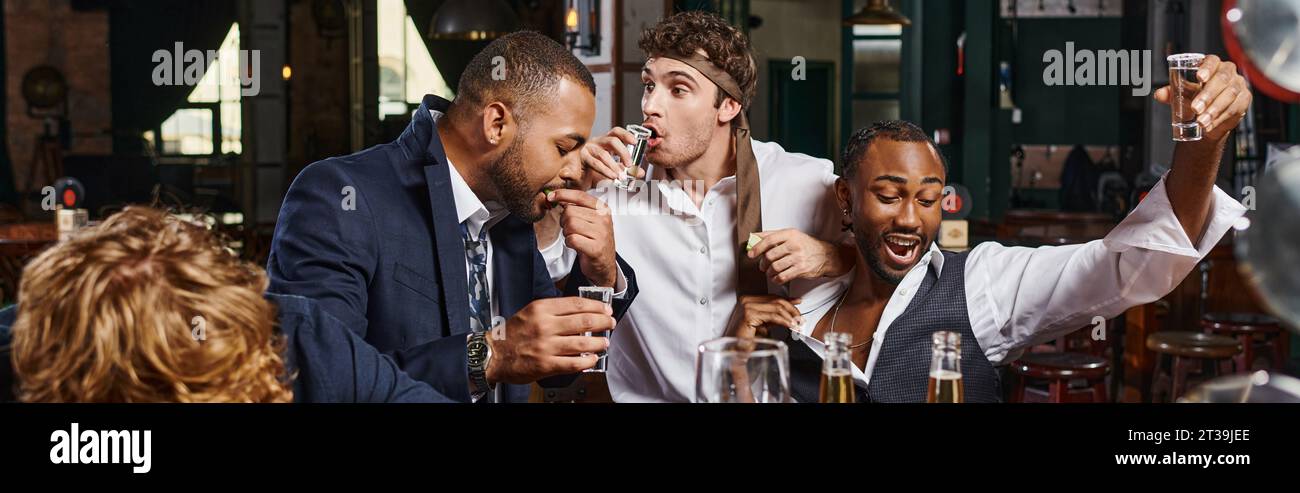 banner of funny and drunk multicultural men in formal wear drinking ...