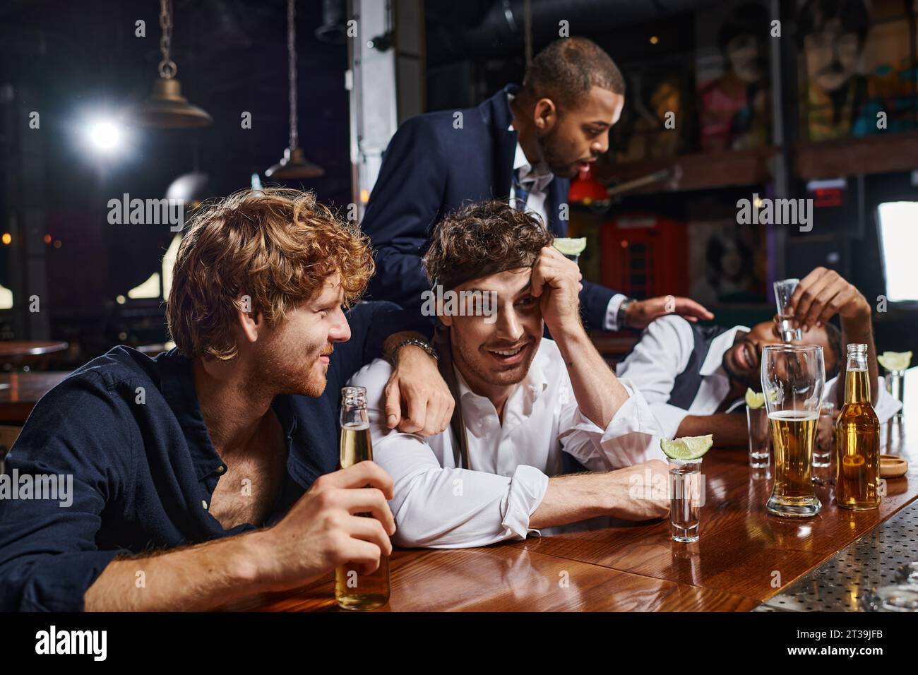 drunk male friends talking after drinking tequila and beer in bar ...