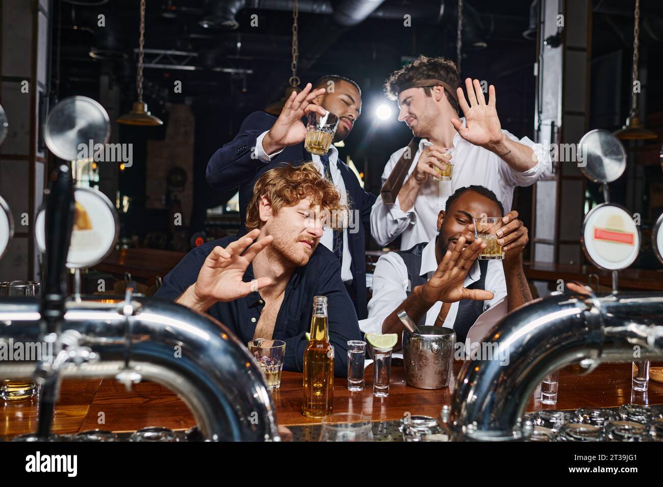 four drunk multicultural friends covering faces from bright light ...