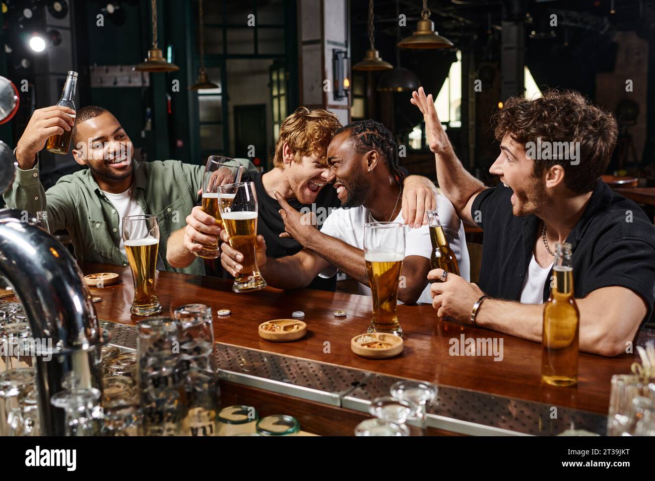 Group Of Four Happy Multiethnic Male Friends Holding Glasses Of Beer