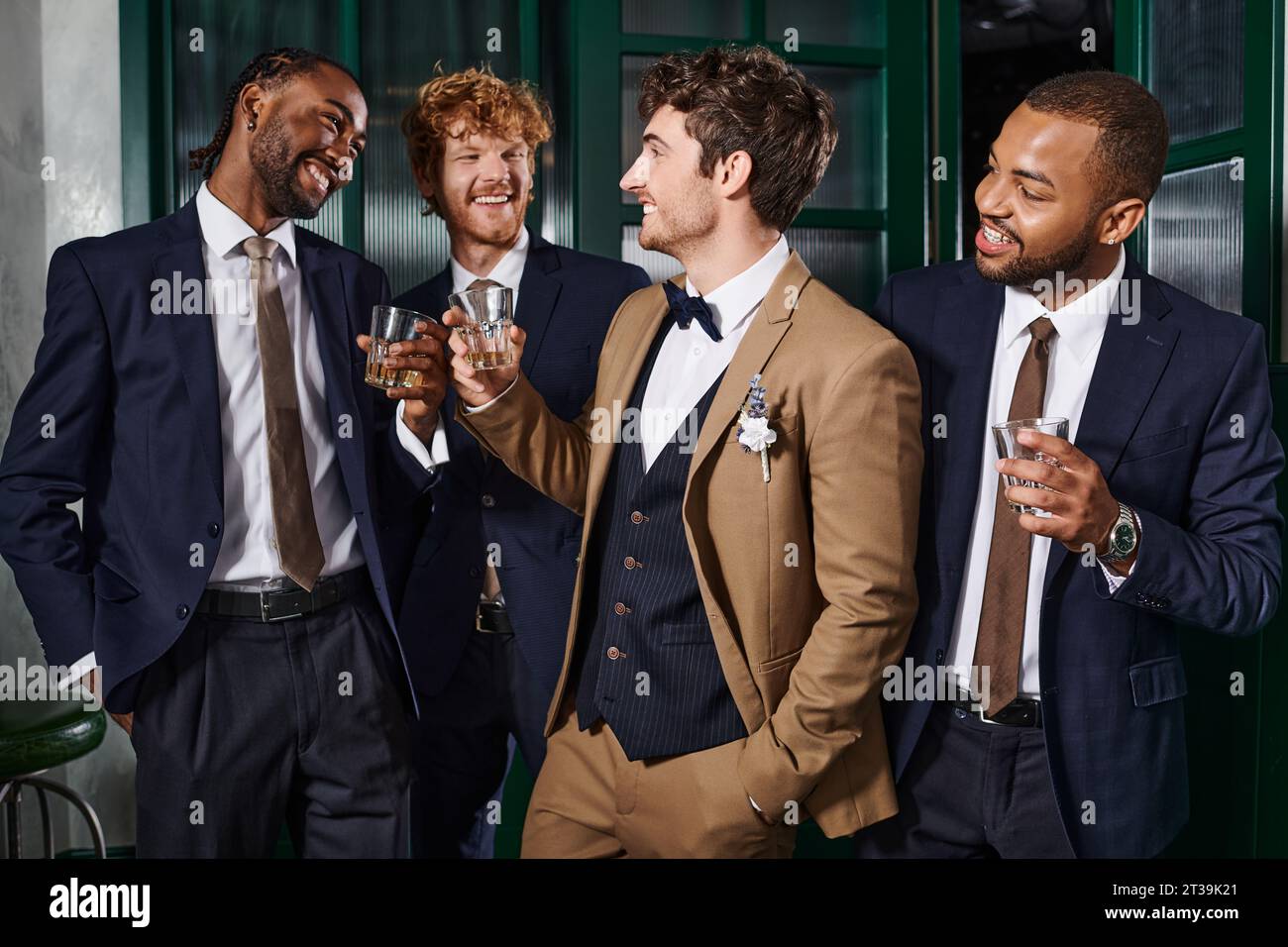 bachelor party, multiethnic best men toasting glasses of whiskey with ...