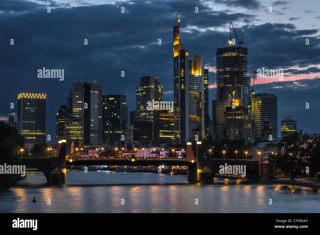 Blue hour cityscape of Frankfurt skyline with dark clouds and fiery red ...