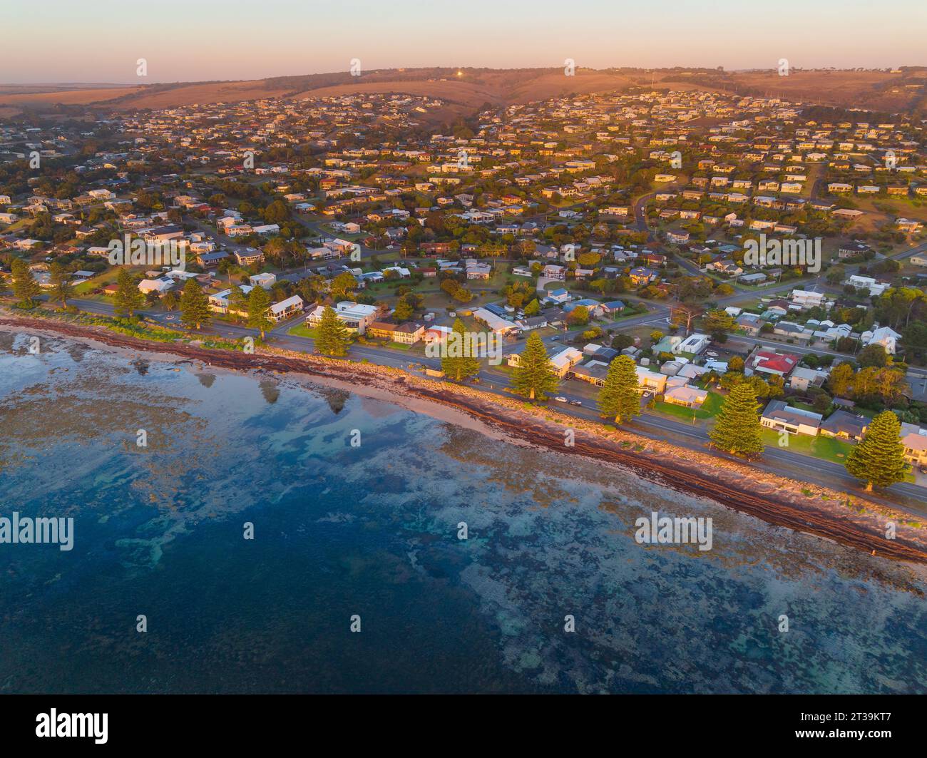 Aerial view of residential area along the shoreline of a sheltered bay ...
