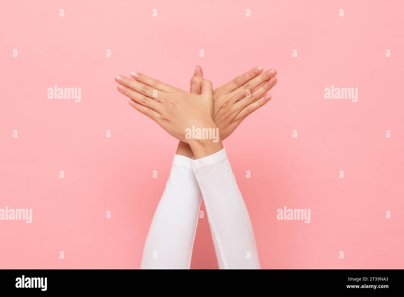 Bird hand gesture sign in isolated pink studio background Stock Photo ...