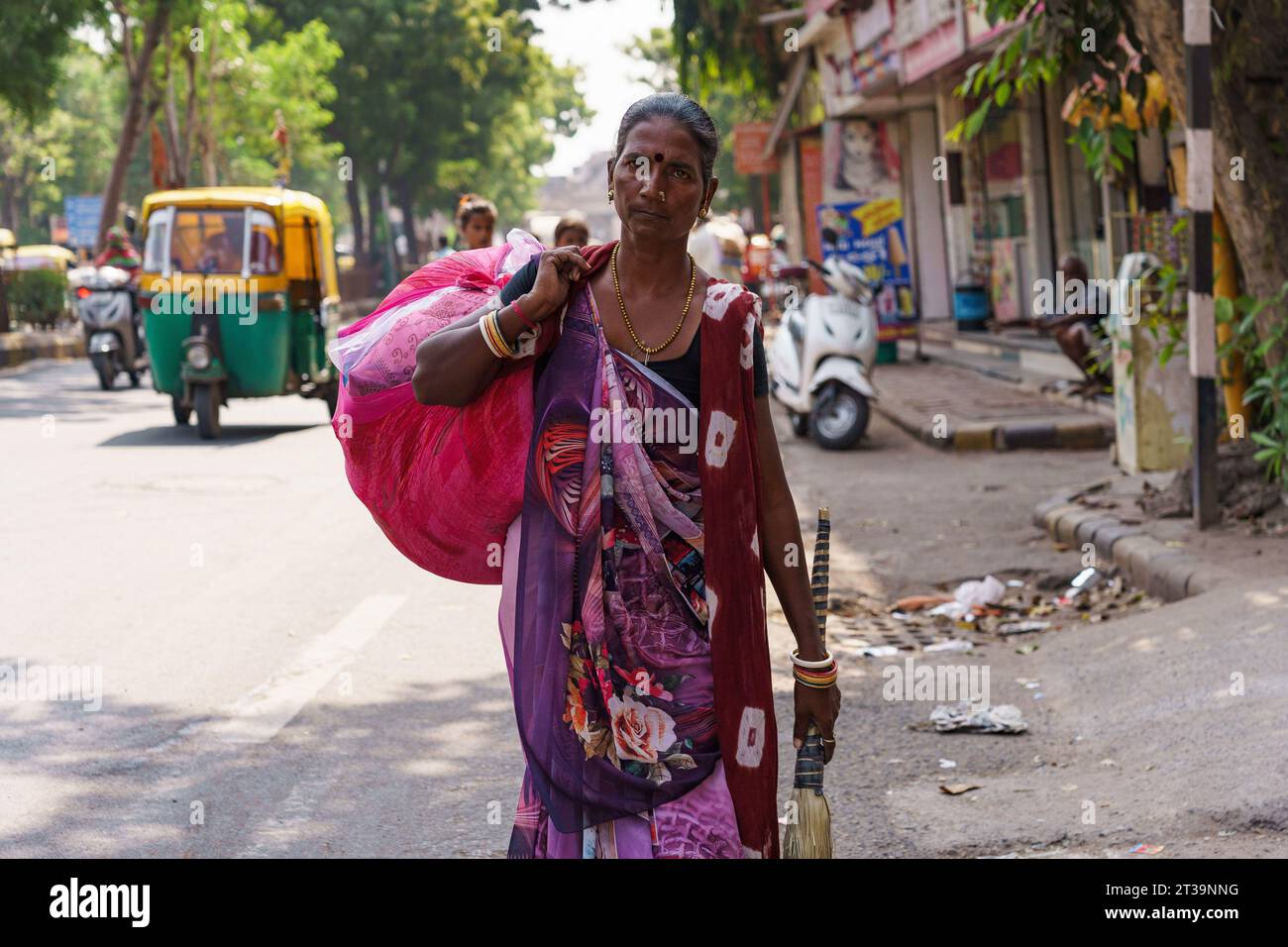 A woman from the lower class is seen walking on the street. According ...