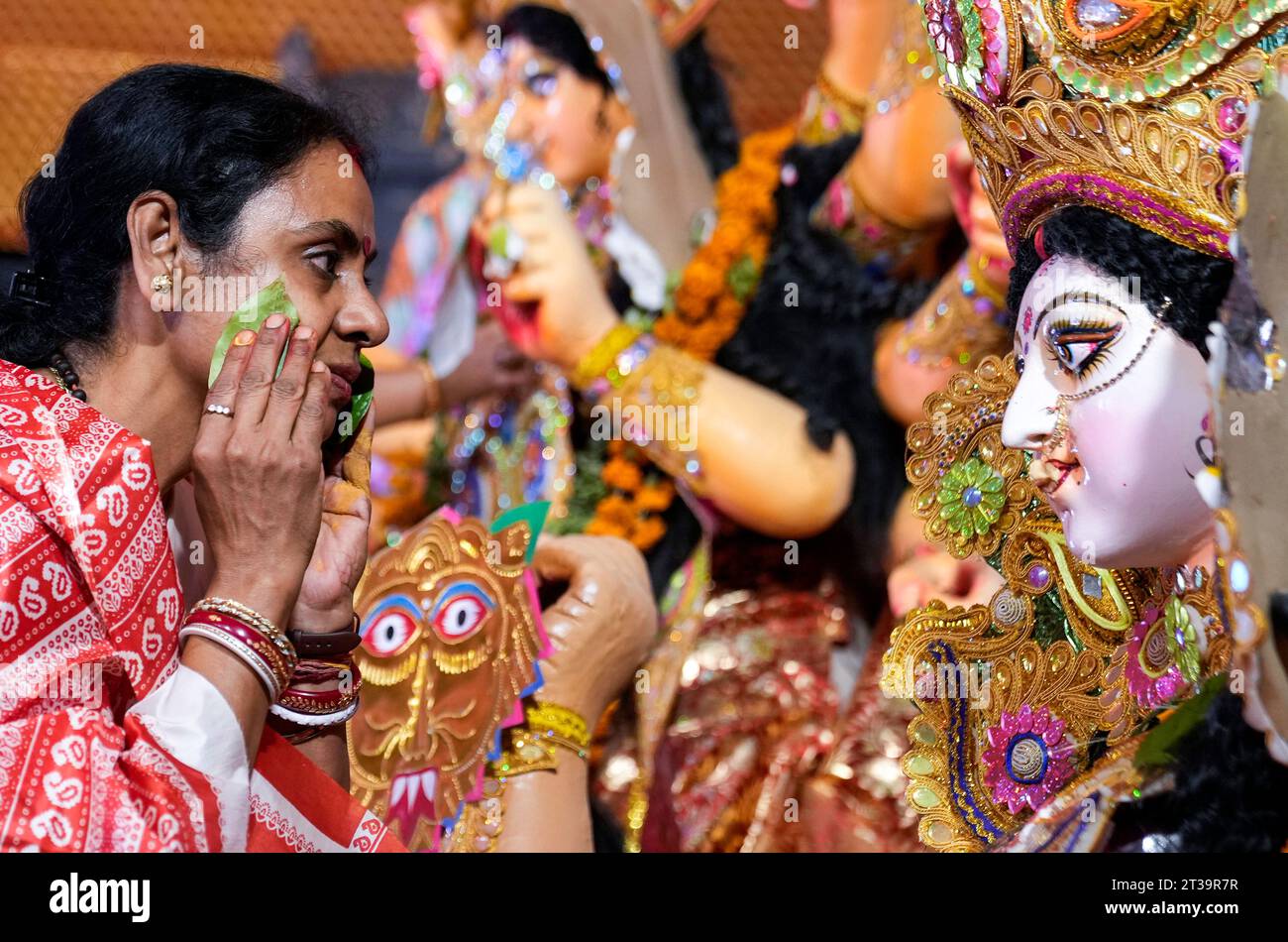 Hindu devotee performs rituals to an idol of goddess Durga during the ...