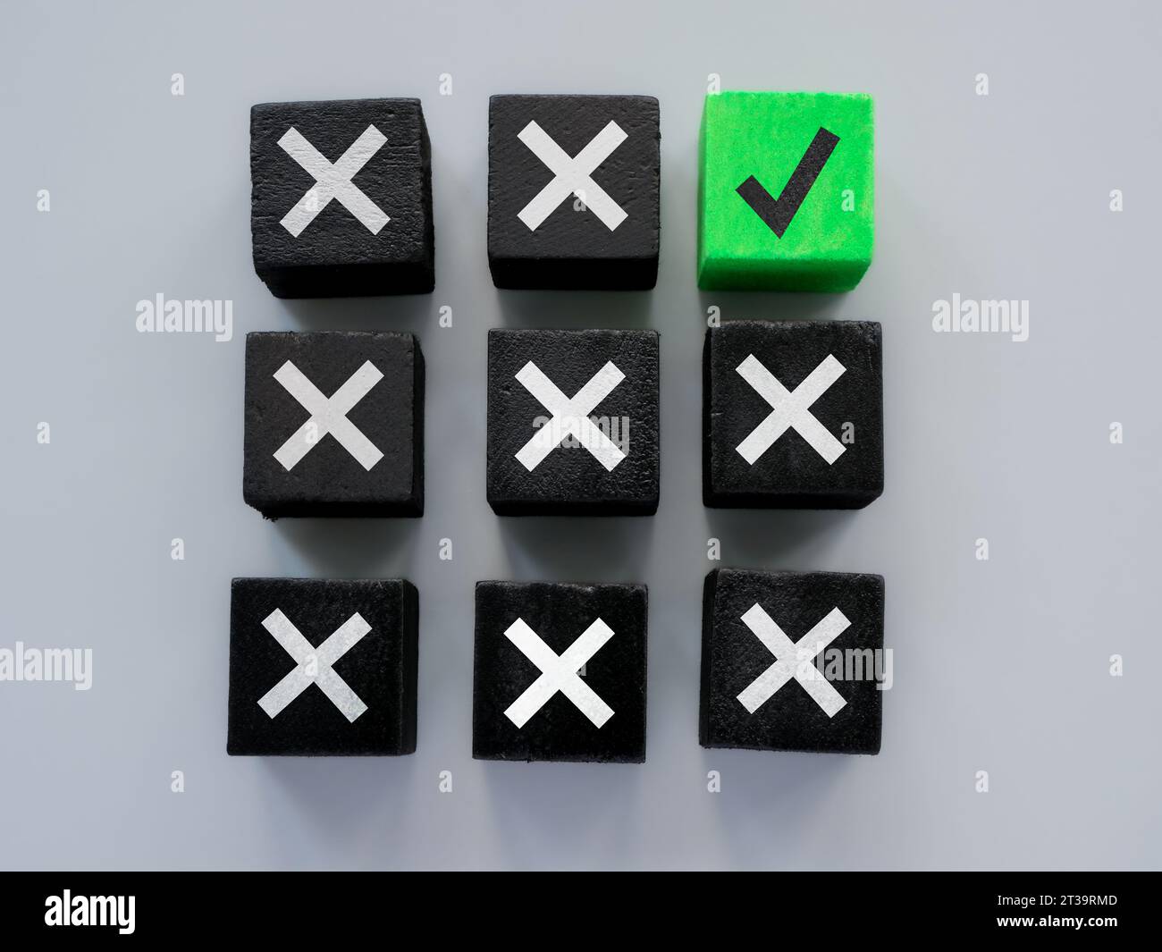 Black cubes and one green as concept for errors and correct answer or ...