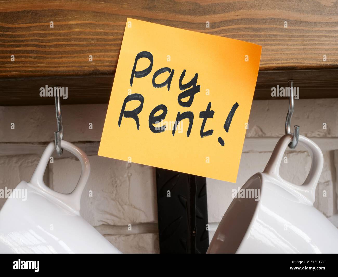 Pay rent reminder attached to the shelf Stock Photo - Alamy