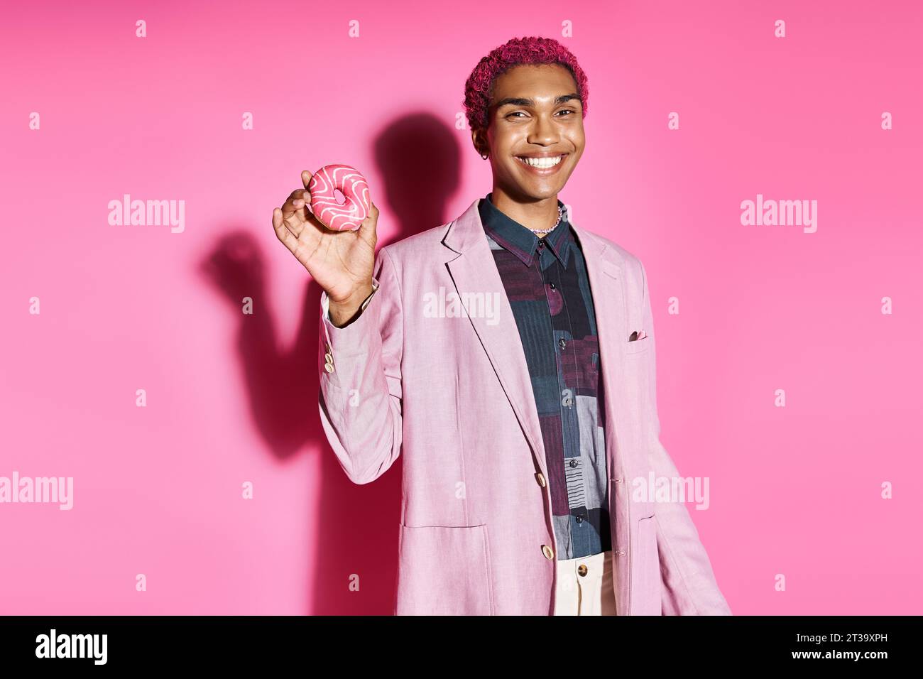 joyous man in vibrant outfit smiling unnaturally at camera and holding ...