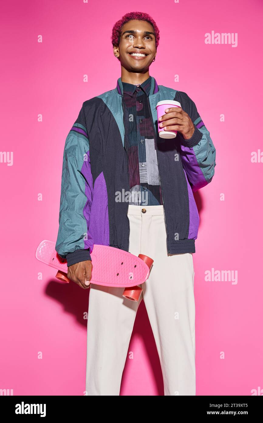 stylish african american man standing still smiling weirdly with coffee ...