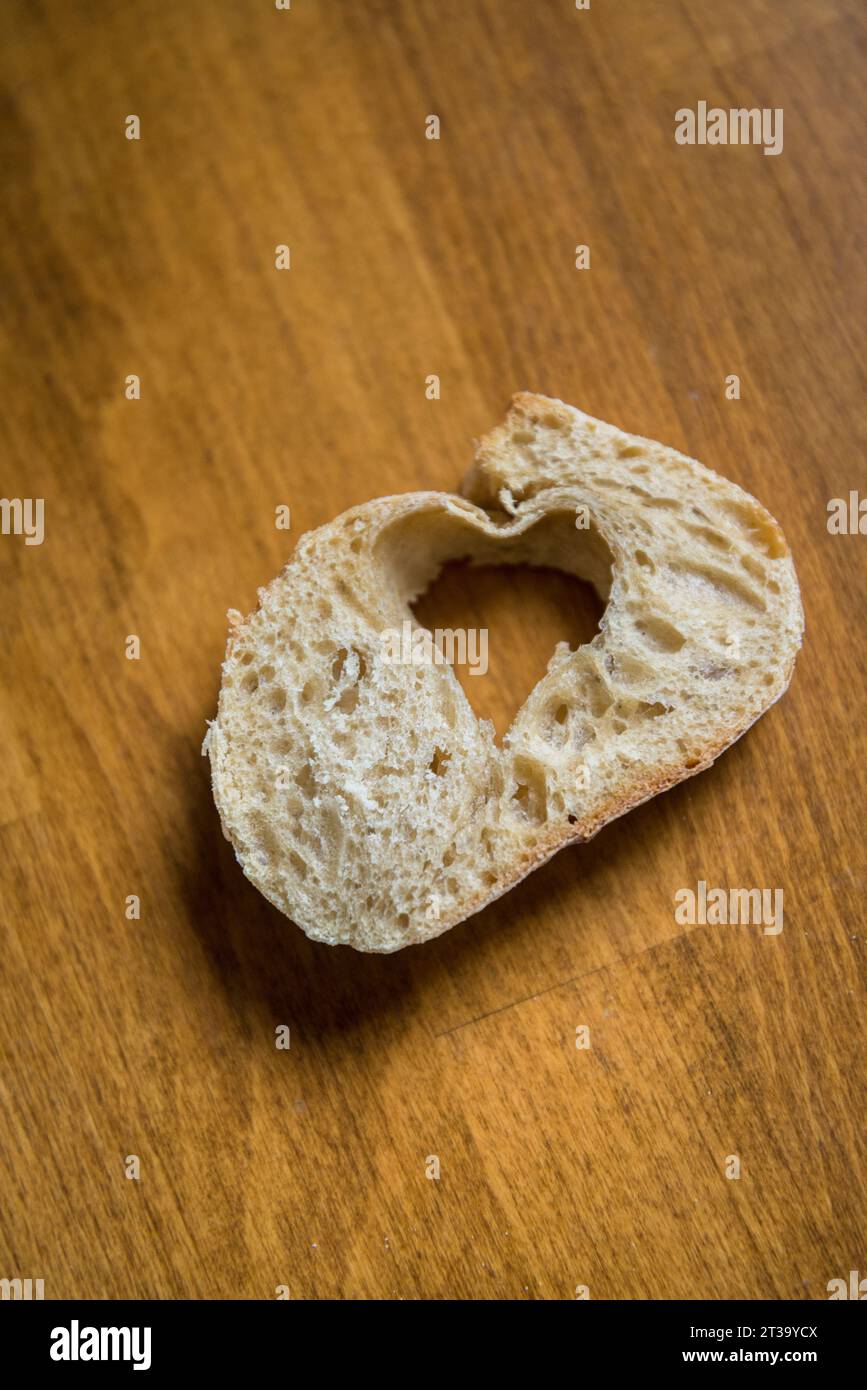A slice of sourdough bread with a heart shape, formed by pure chance of ...