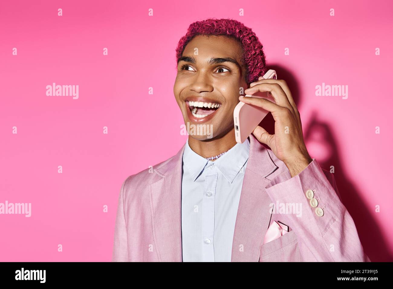 cheerful young african american male model in pink blazer posing with ...