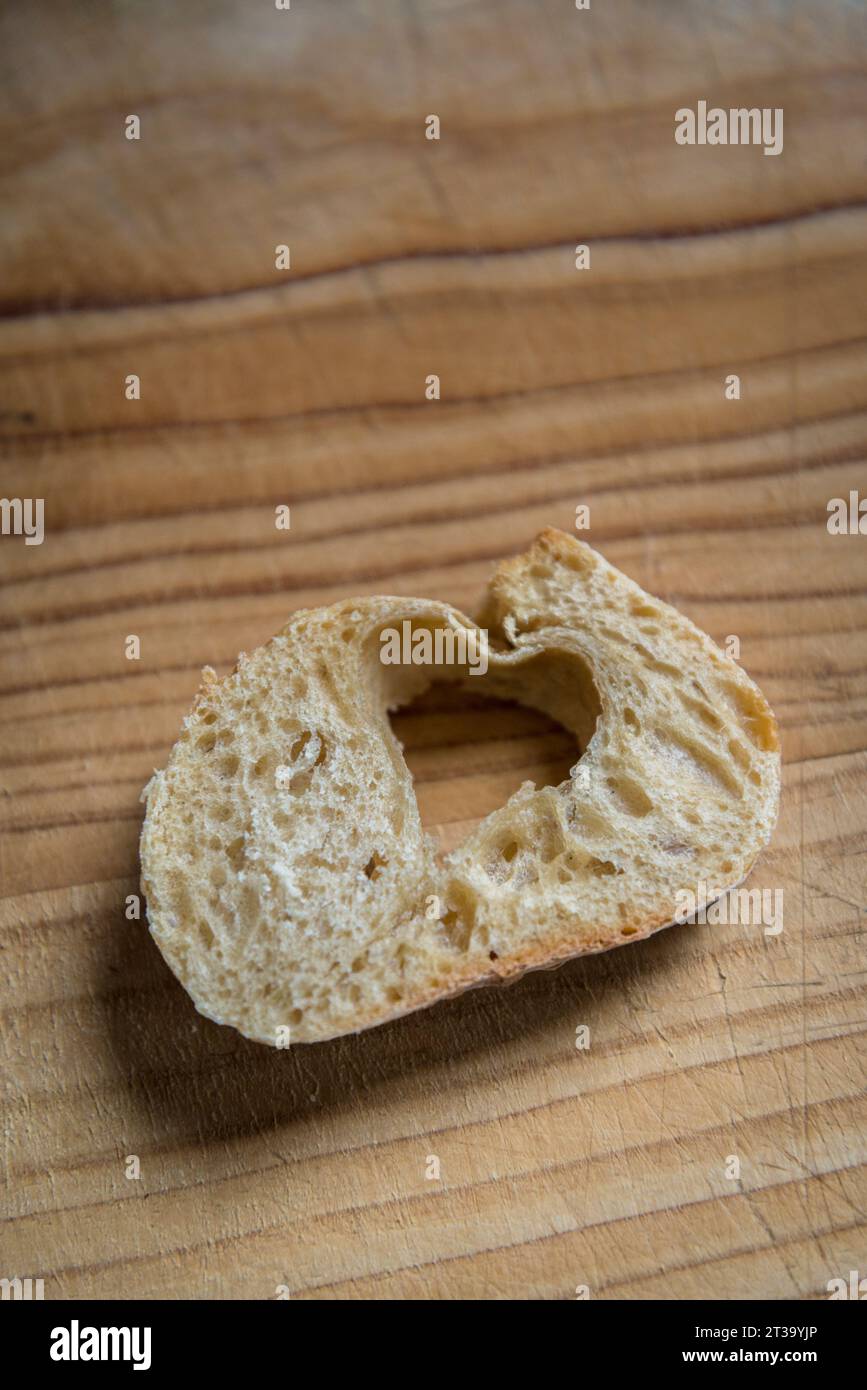 A slice of sourdough bread with a heart shape, formed by pure chance of ...