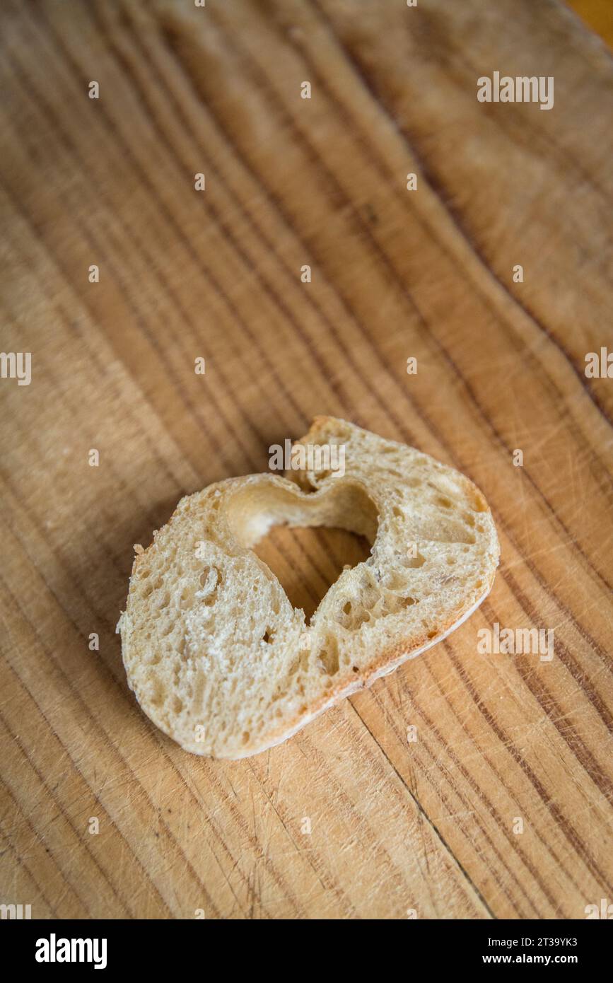 A slice of sourdough bread with a heart shape, formed by pure chance of ...