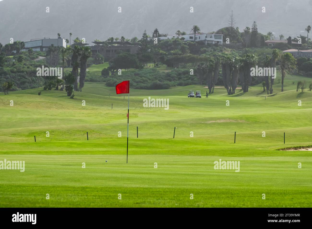 Beautiful golf course with a red flag close-up Stock Photo - Alamy