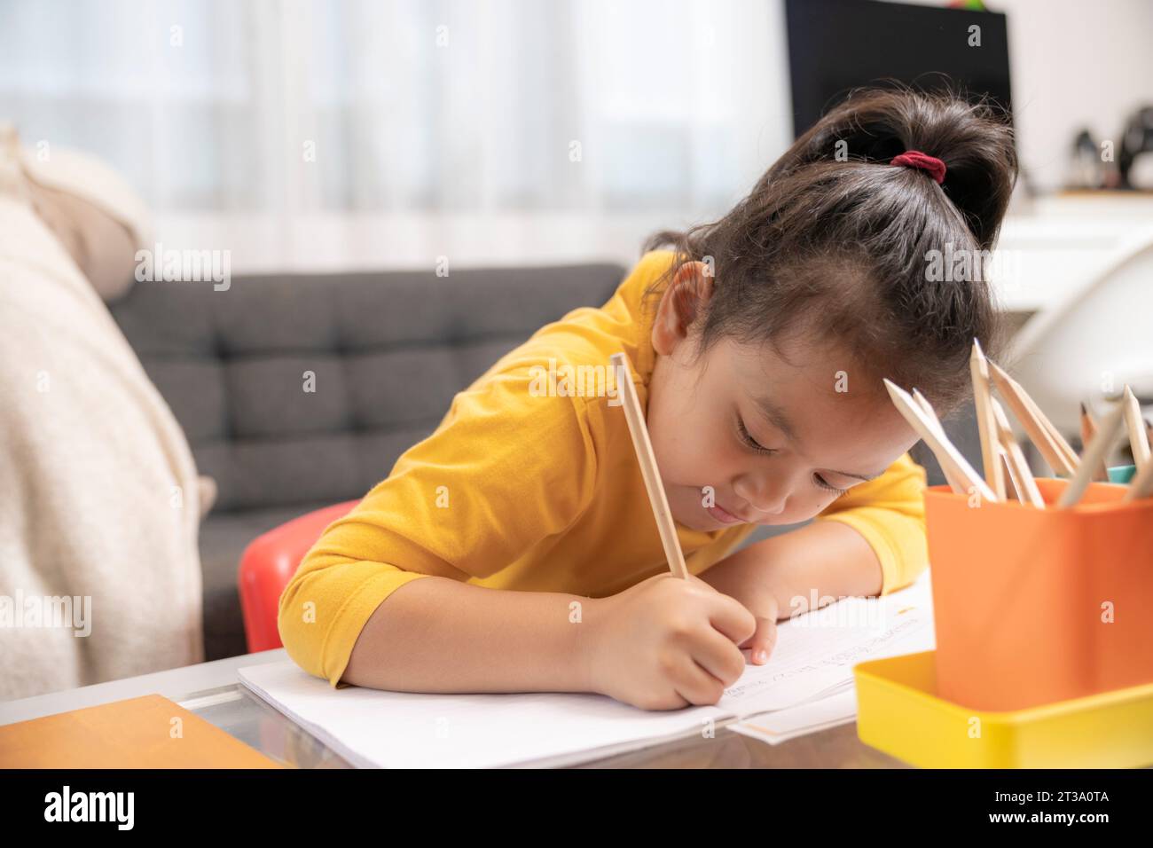 Little girl doing homework at home Stock Photo - Alamy
