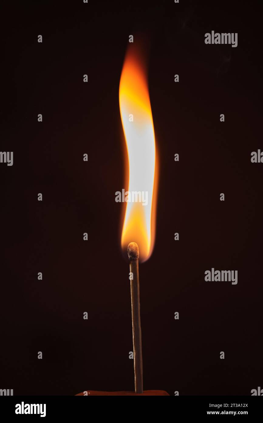 a lighted match on a dark background Stock Photo - Alamy