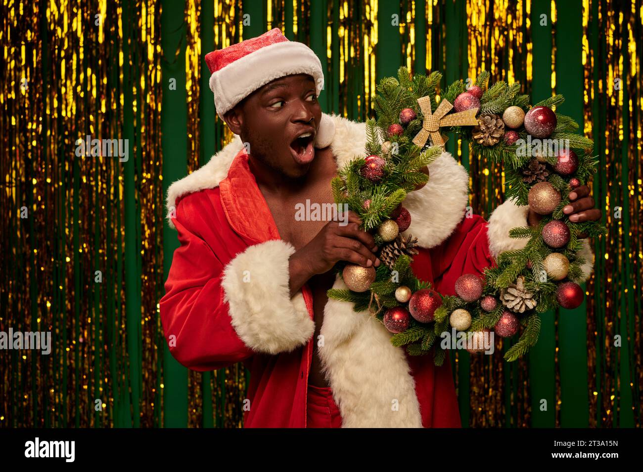 thrilled african american man in santa costume looking at christmas ...