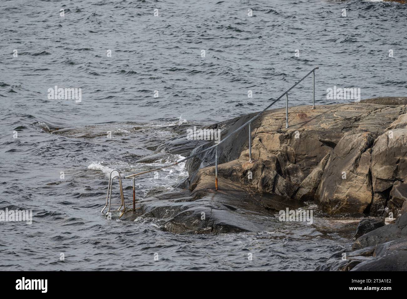 Metal railings and bathing ladder on cliffs at sea Stock Photo - Alamy