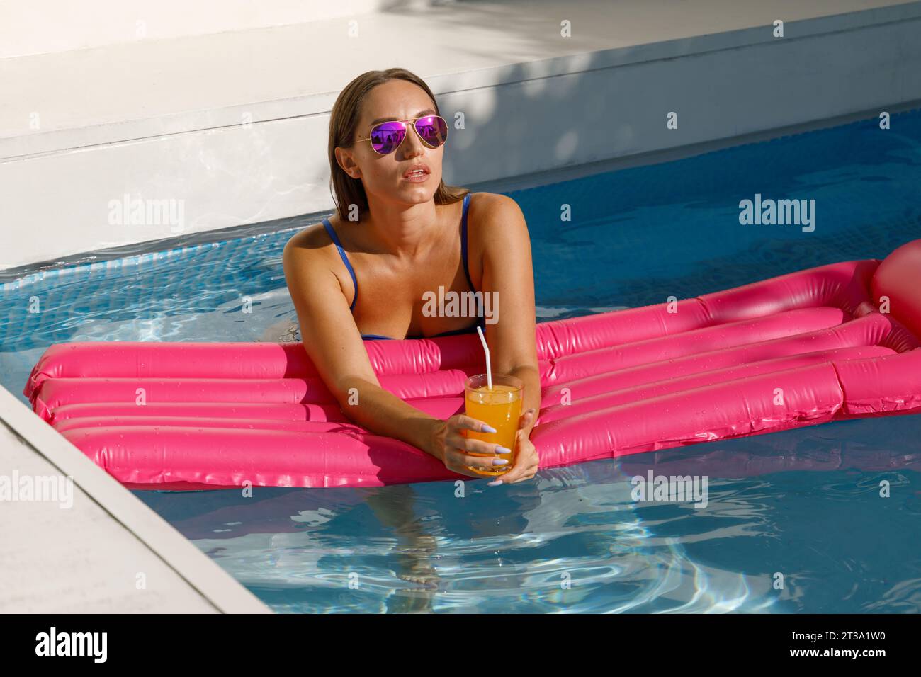 Chic Summer Days: Stylish Girl on Inflatable Raft in Pool Stock Photo - Alamy