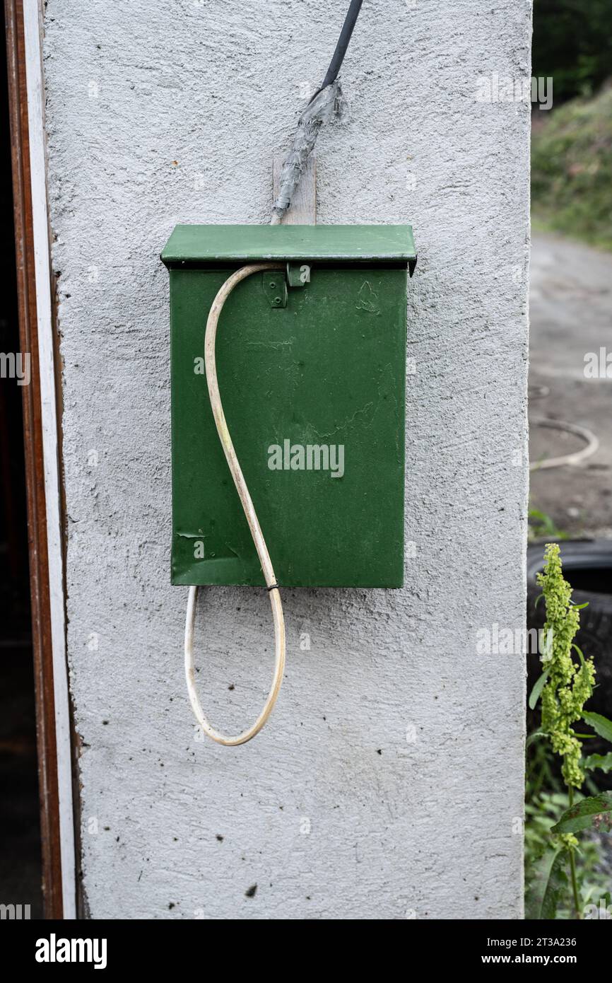 Green post box with a mysterious hos sticking out of it Stock Photo - Alamy