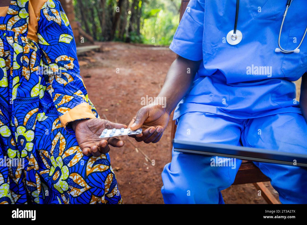 A doctor gives medicines to an elderly patient while explaining the ...