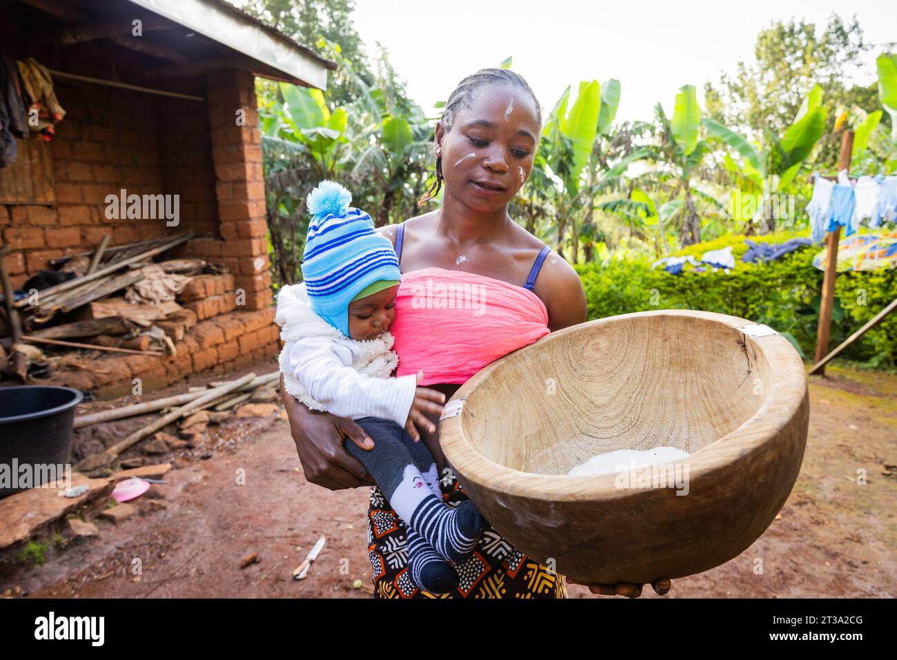 Portrait of a beautiful young African mother holding her baby and ...