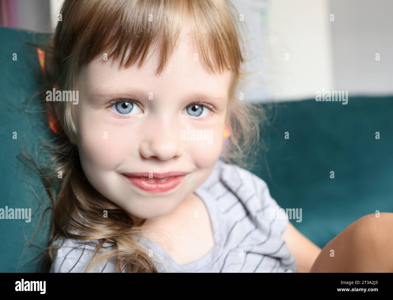 Portrait of little girl with blue eyes and slight smile Stock Photo - Alamy