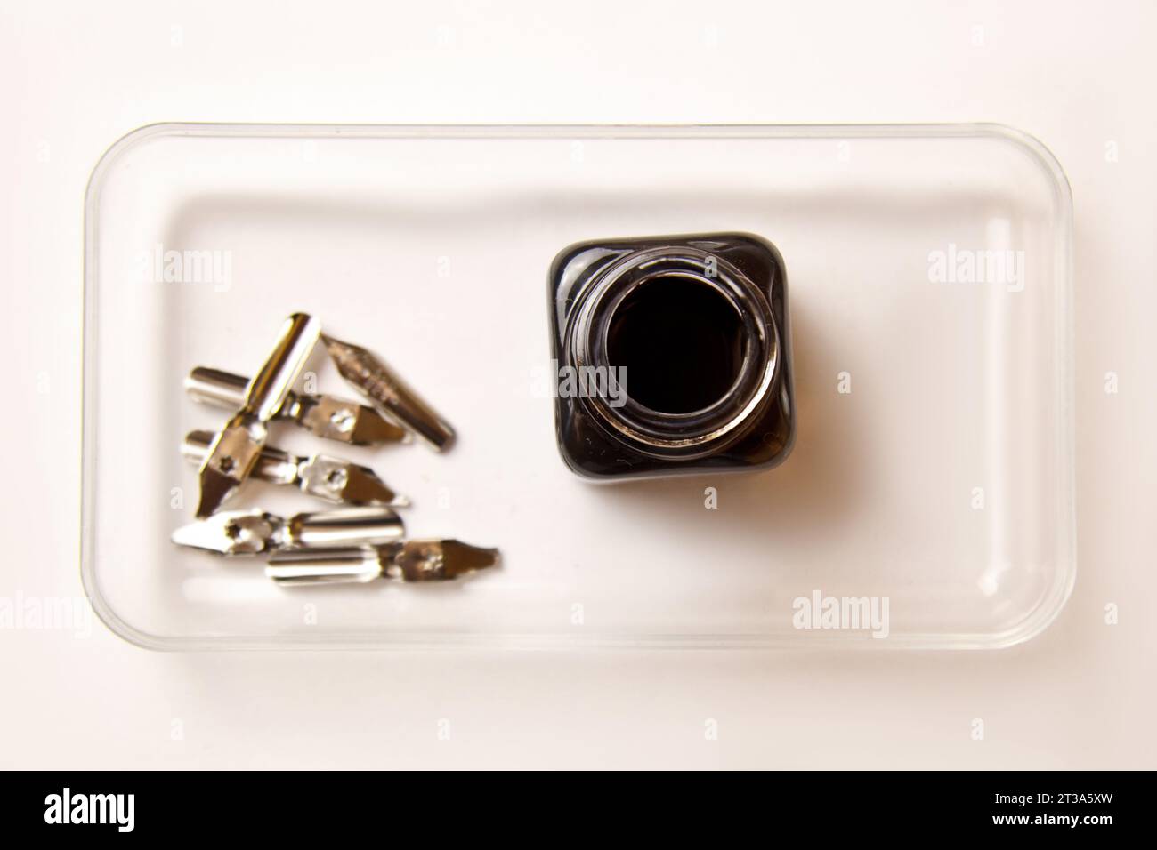 ink bottle with metal tips for ink pen on a white background ...