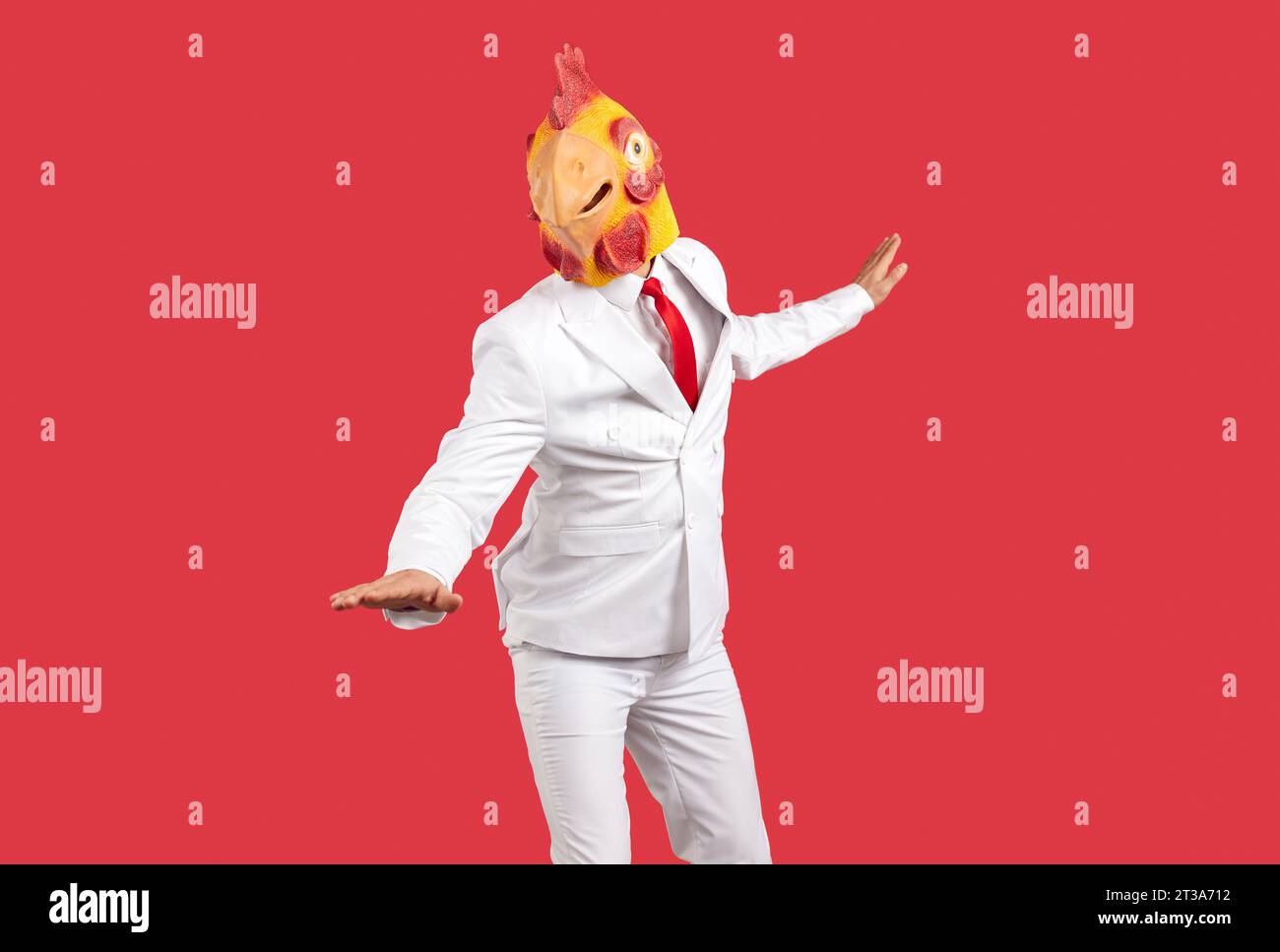 Guy wearing suit and funny chicken head dancing and having fun at crazy ...