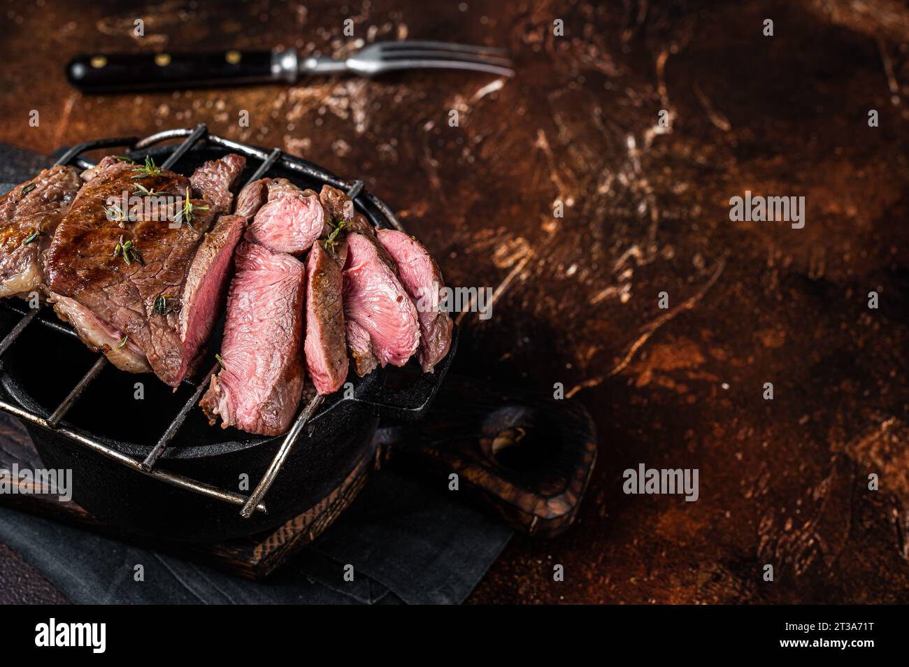 BBQ grilled Mutton fillet chop steaks, sliced lamb meat. Dark ...