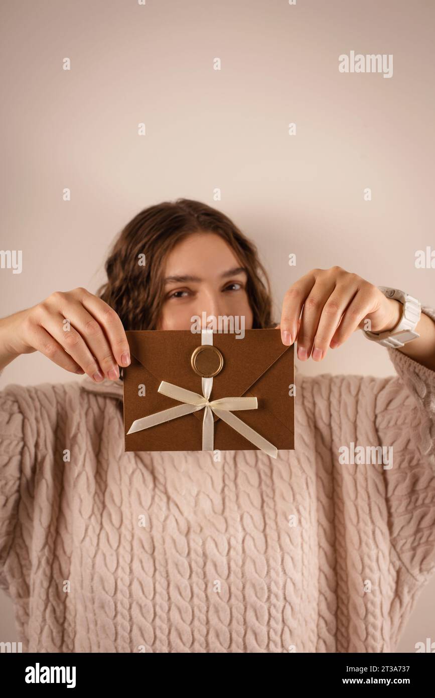 Get surprise Girt. woman hands holding handmade bronze envelope with ...
