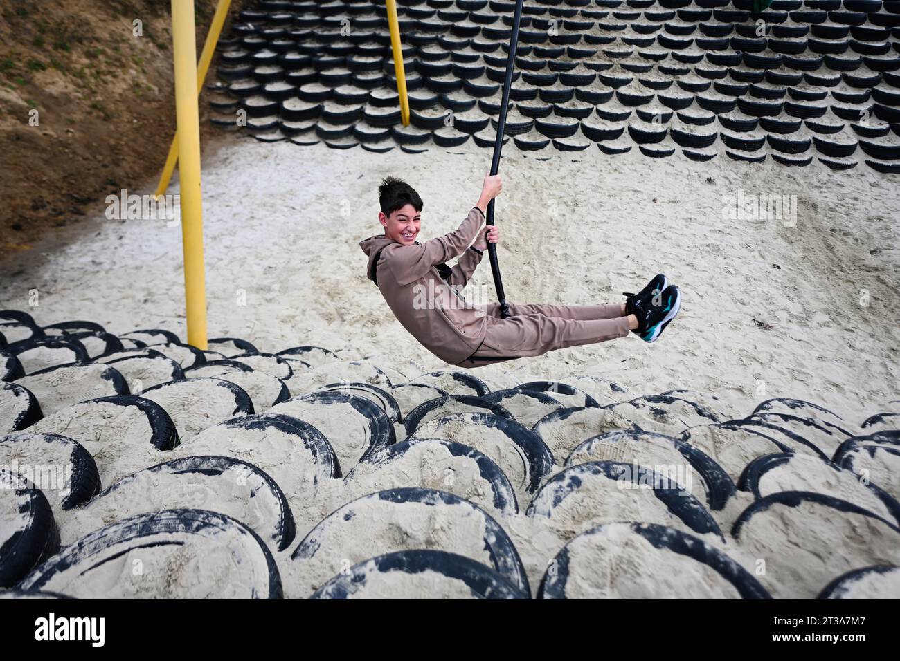 Teen boy doing acrobatic tricks on a track Stock Photo - Alamy