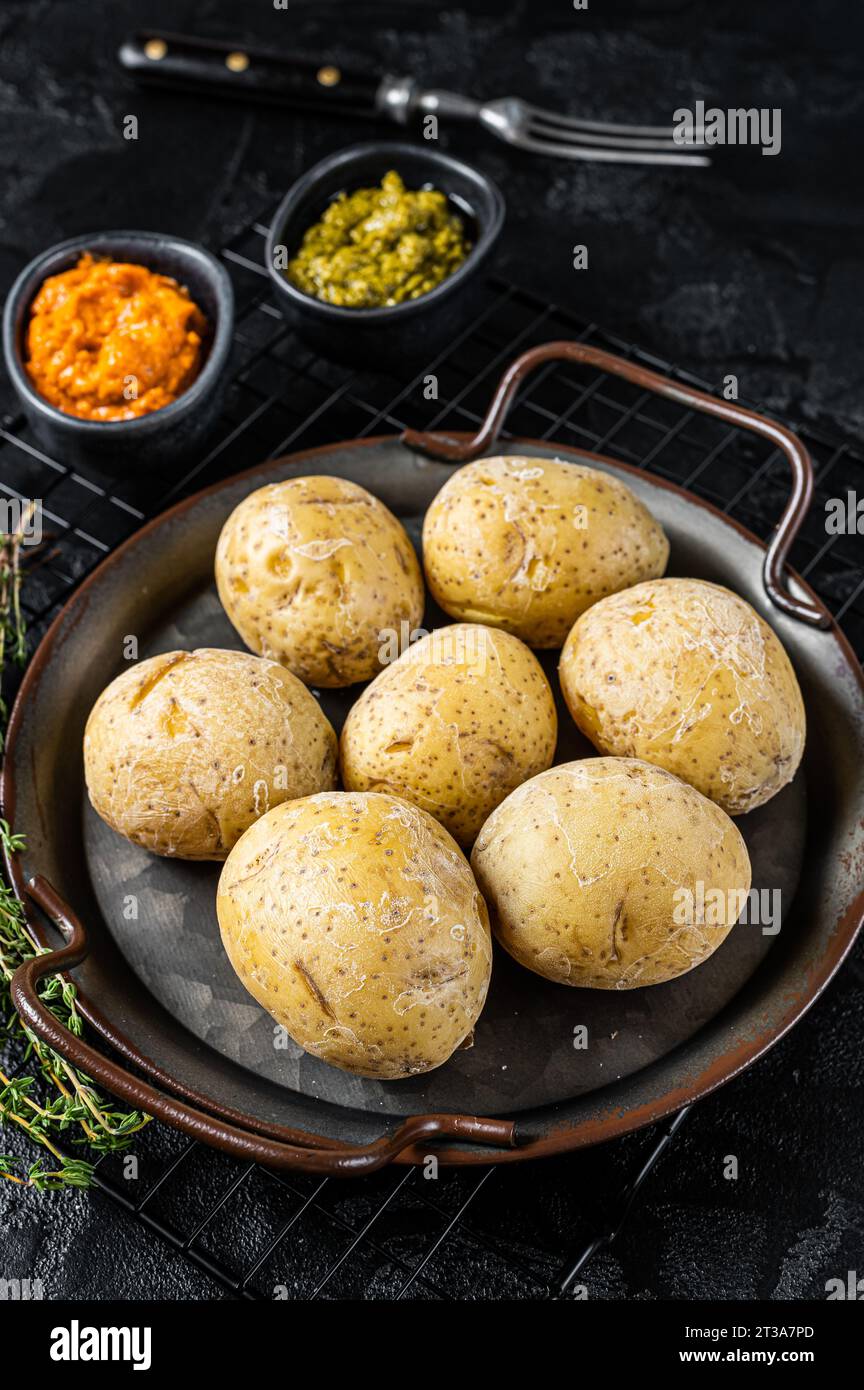 Canarian potatoes papas arrugadas with mojo, hot sauce. Black ...