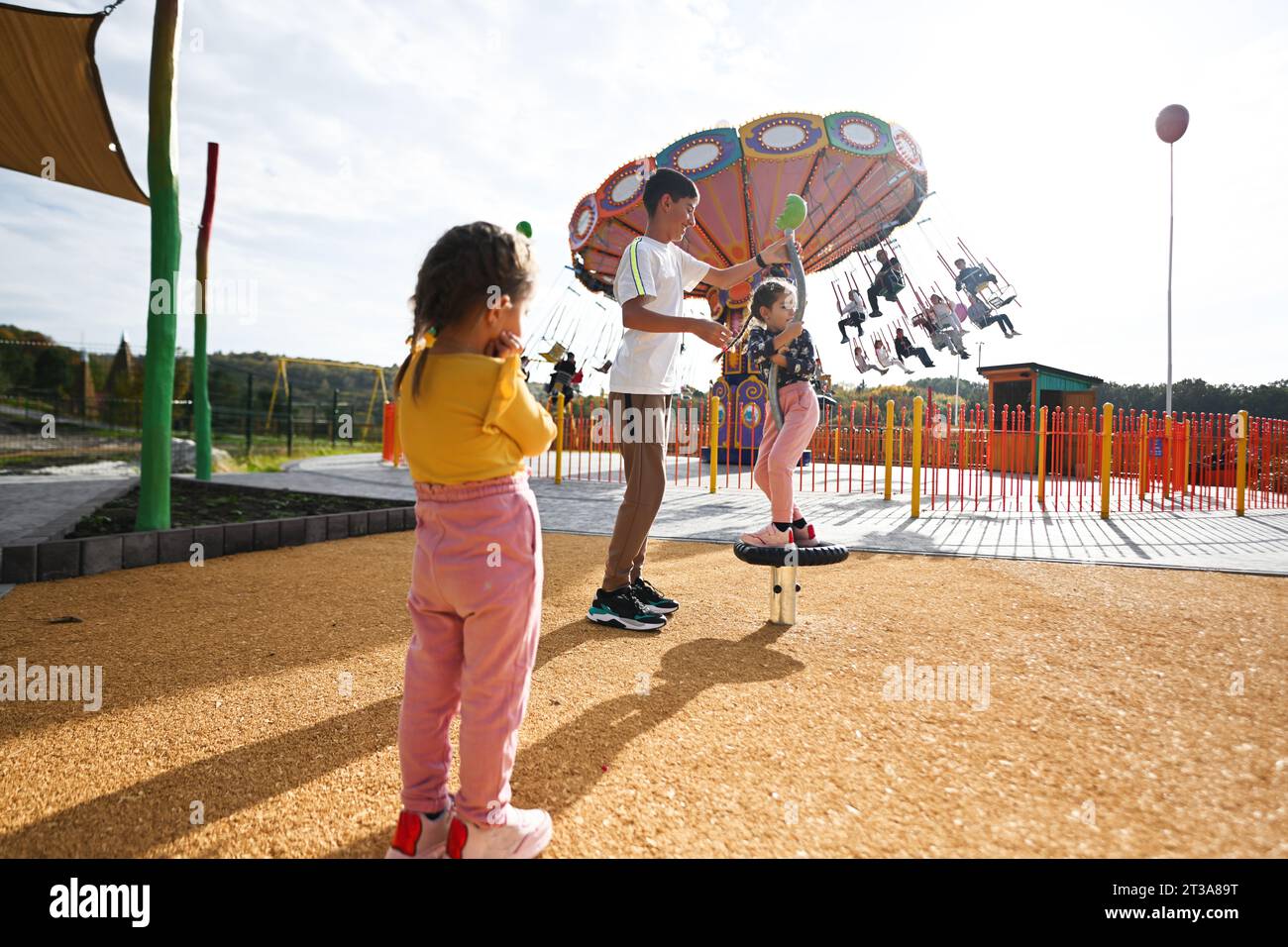 Children having fun in amusement park on sunny summer day. Kids playing ...