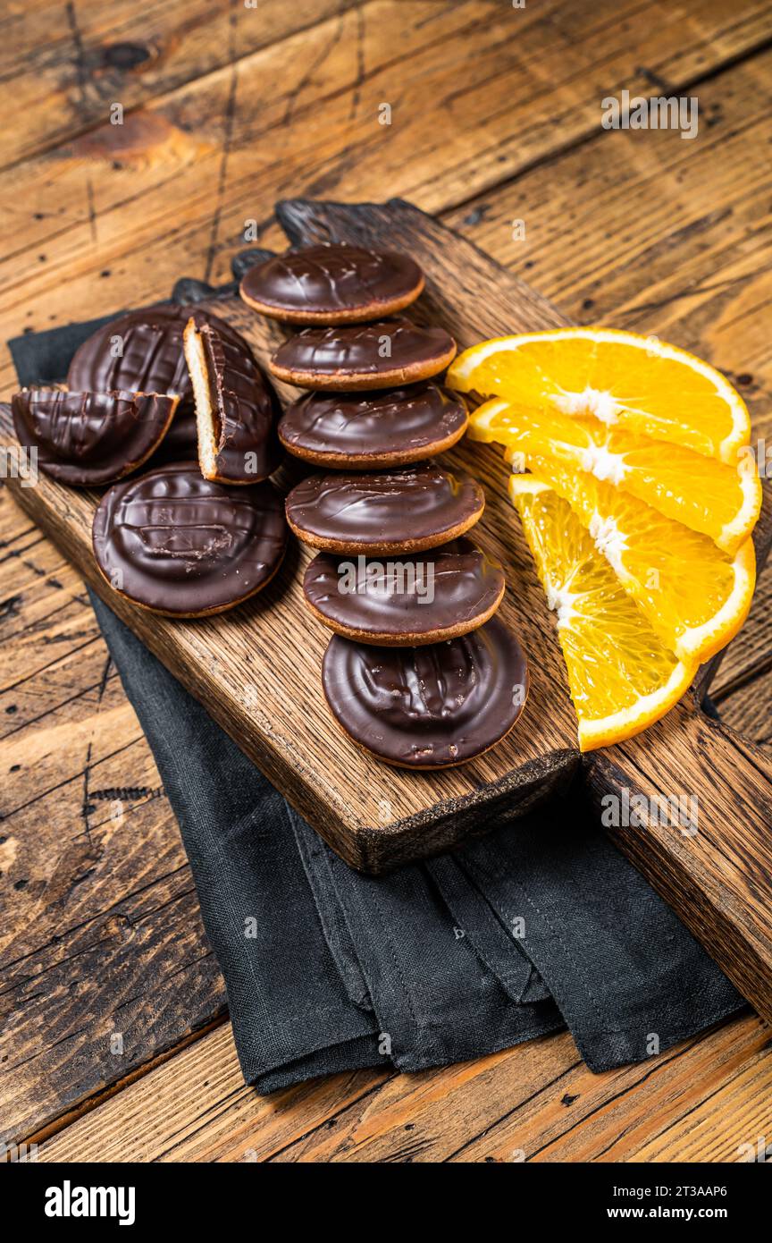 Chocolate Jaffa Cakes with Orange Flavored Marmalade. Wooden background ...