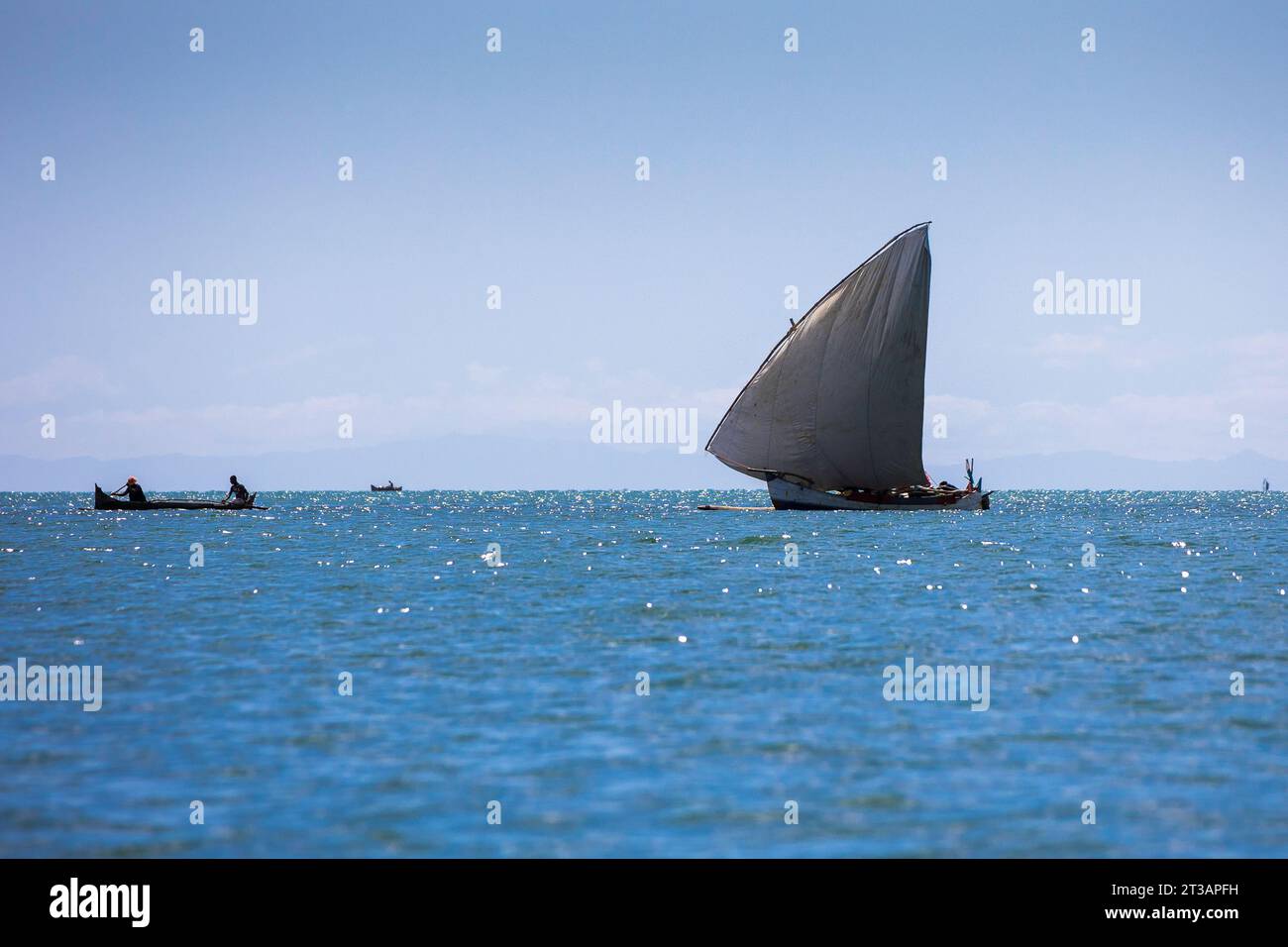 Large wooden hand built boat with it's large sail sailing on the sea in ...