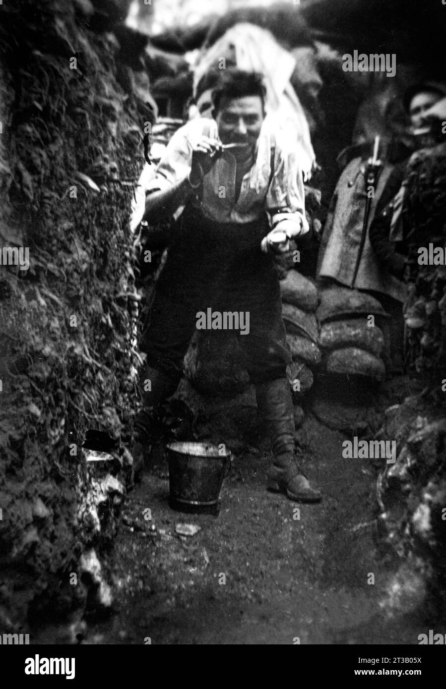 A soldier brushes his teeth inside a trench during the first world war ...