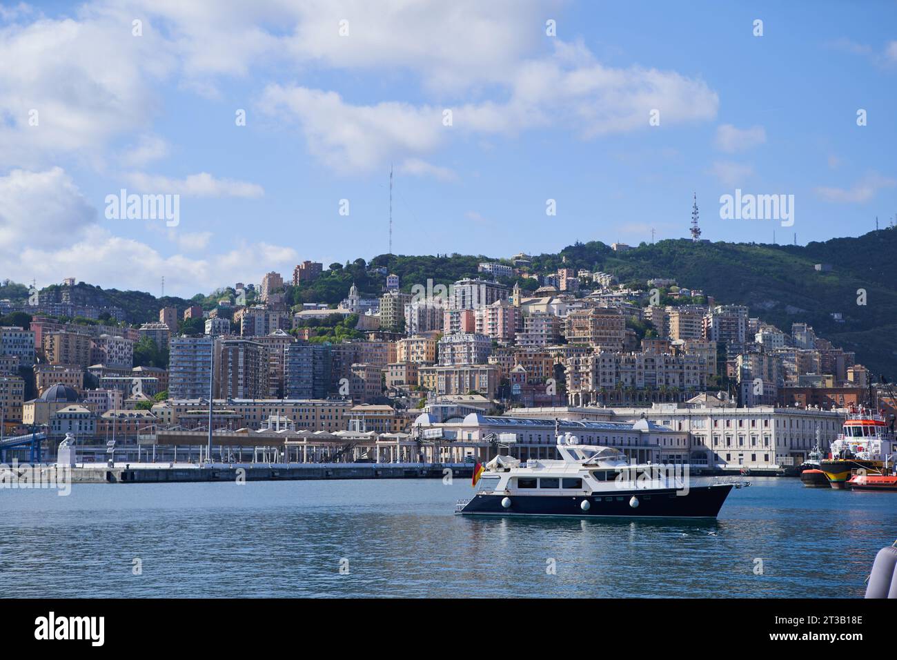 Modern yacht cruising in a harbor of Genoa with Italian houses on the ...
