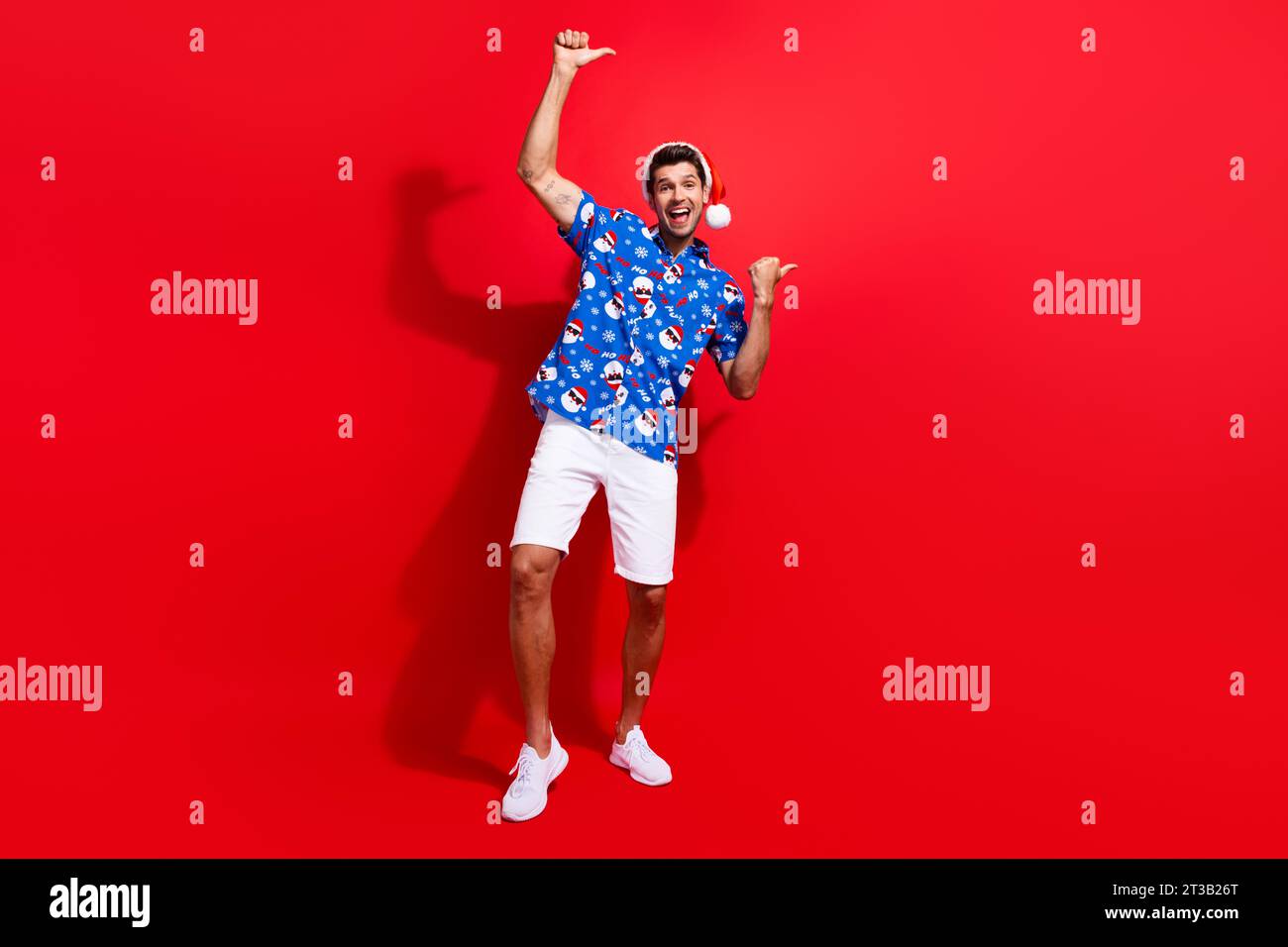 Full length photo of nice young male point empty space promo wear santa ...