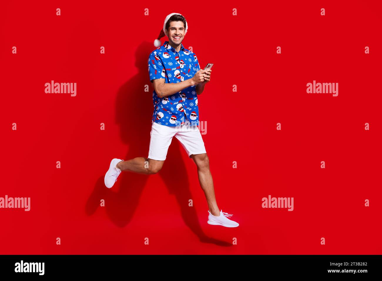 Full length photo of nice young male running hold gadget message wear ...